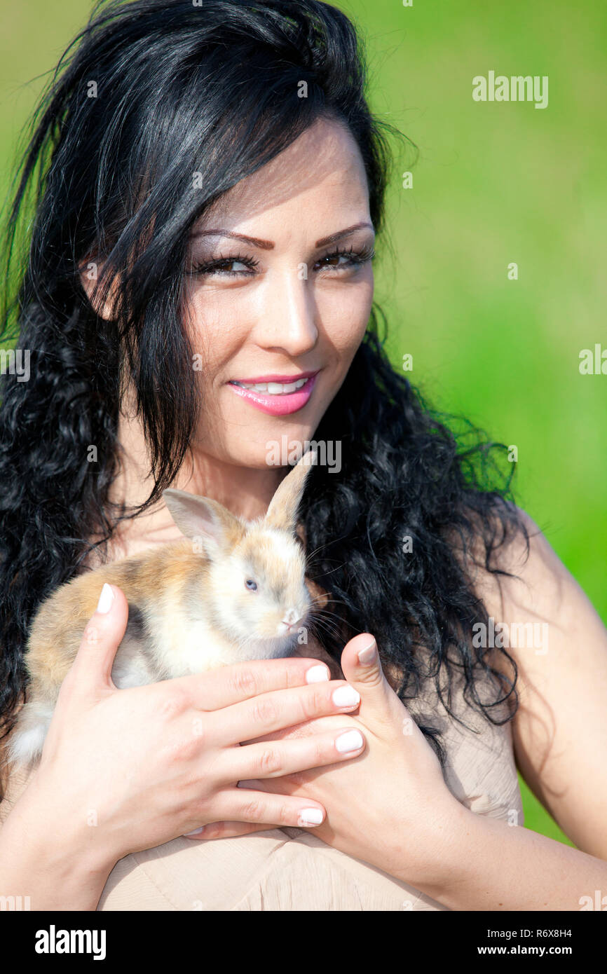 Girl playing with rabbit Stock Photo - Alamy