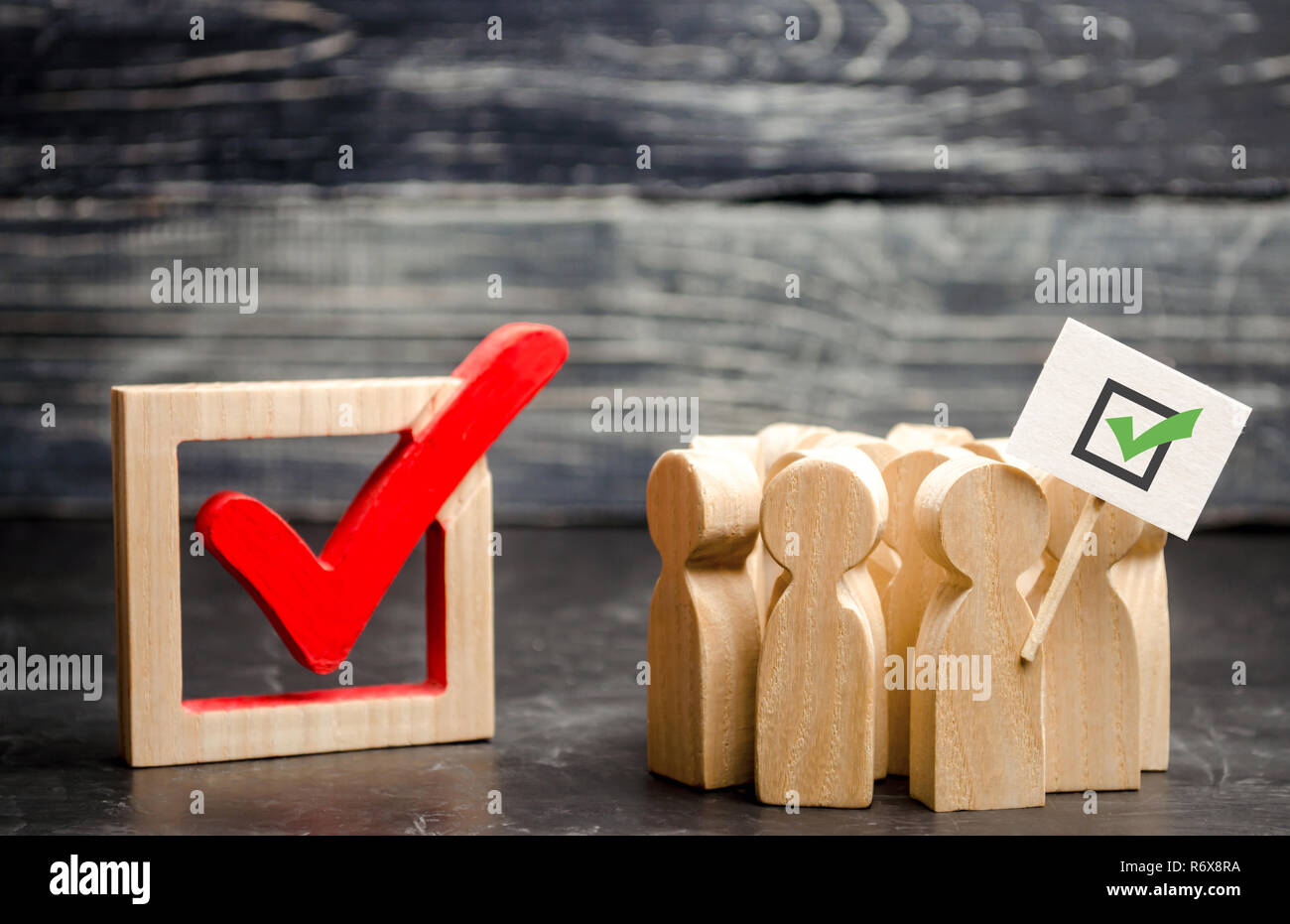 A group of people stand near the tick in the box. Voters and the ...