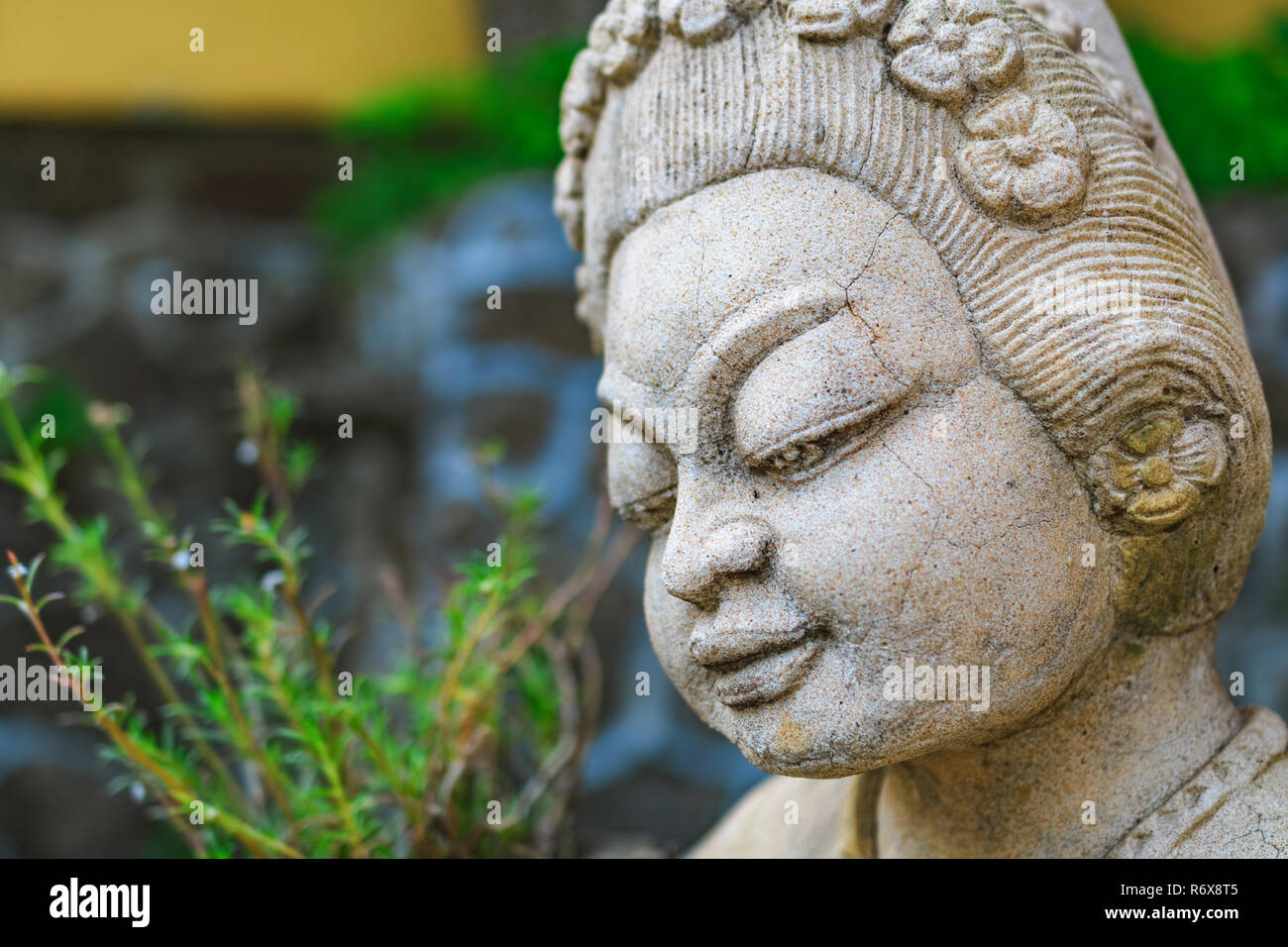figure of the Asian deity from a stone in a silent garden Stock Photo ...