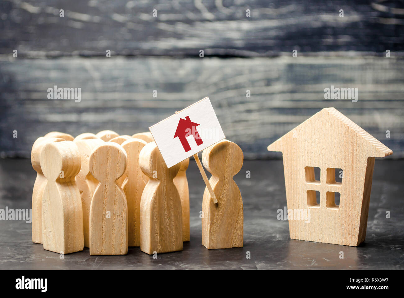 A crowd of people with a poster standing near the house. The concept of ...