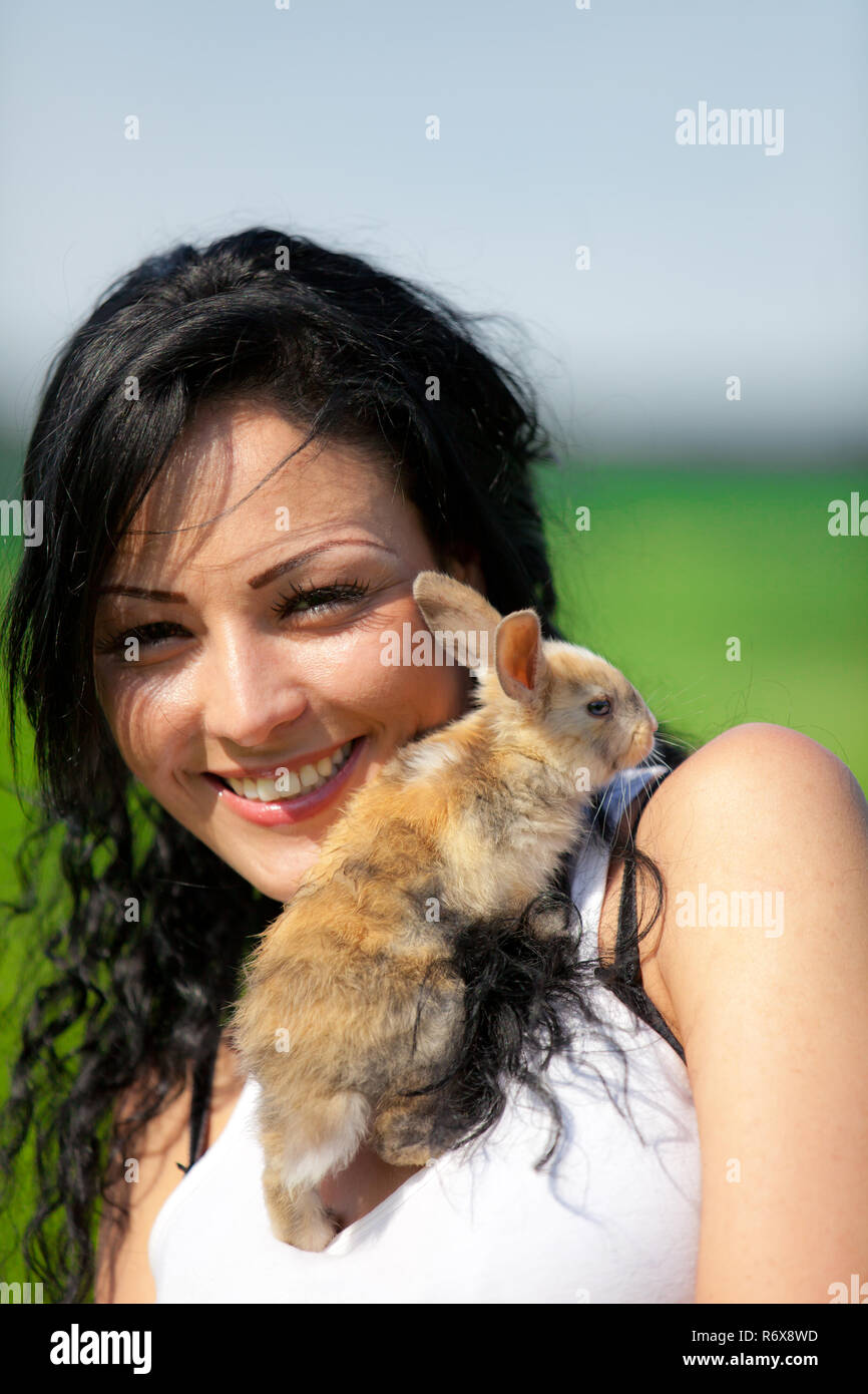 Girl playing with rabbit Stock Photo - Alamy