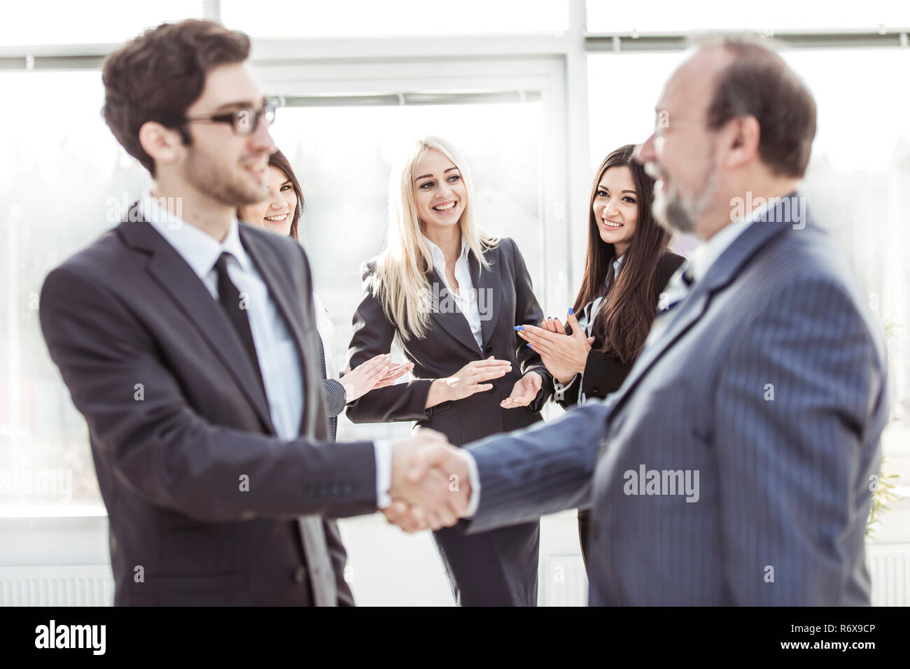 welcome and handshake of business partners on the background of ...