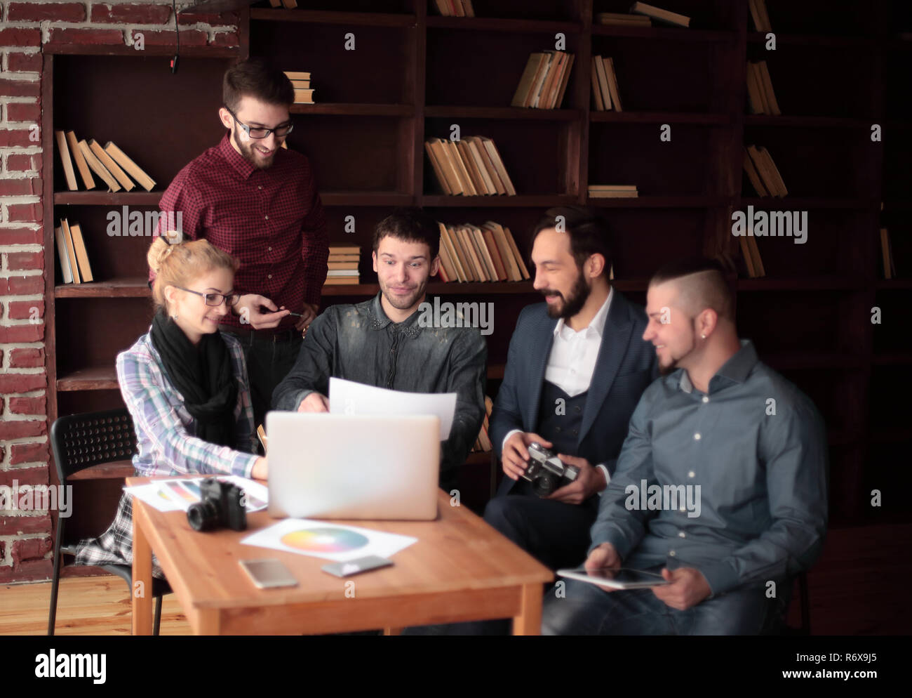 successful group of designers discussing a new advertising project ...