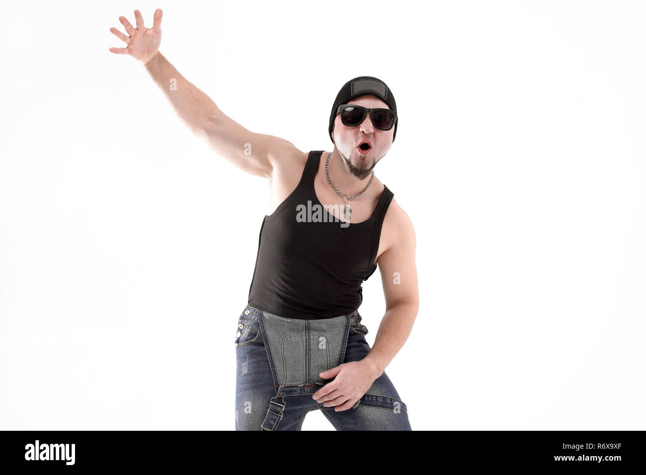 male hip-hop dancer posing in the Studio. Isolated on white background ...