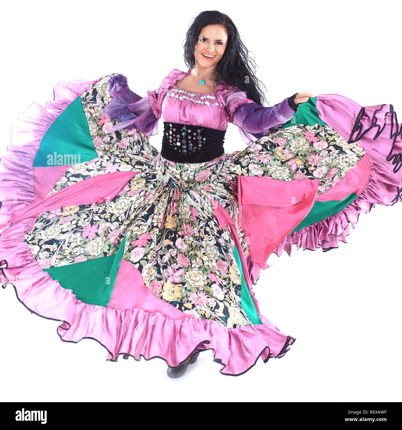 portrait of a beautiful Gypsy dancer performs the dance on a white ...