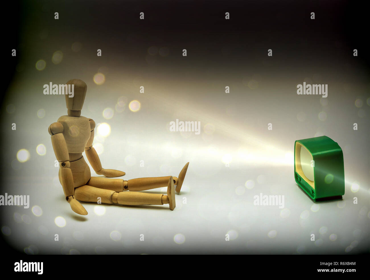 Wooden Doll watching a vintage TV, concept image Stock Photo - Alamy