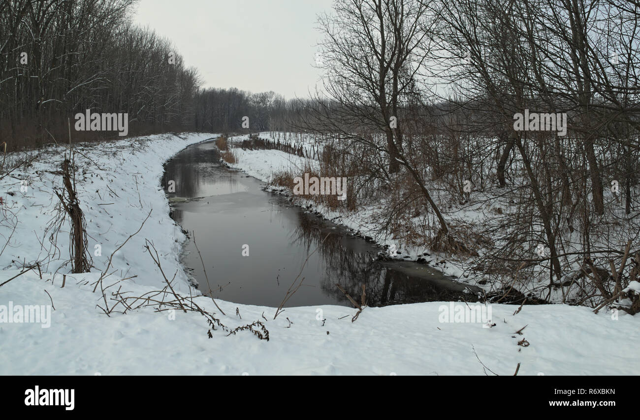 winter landscape with frozen canal and snow all around Stock Photo - Alamy