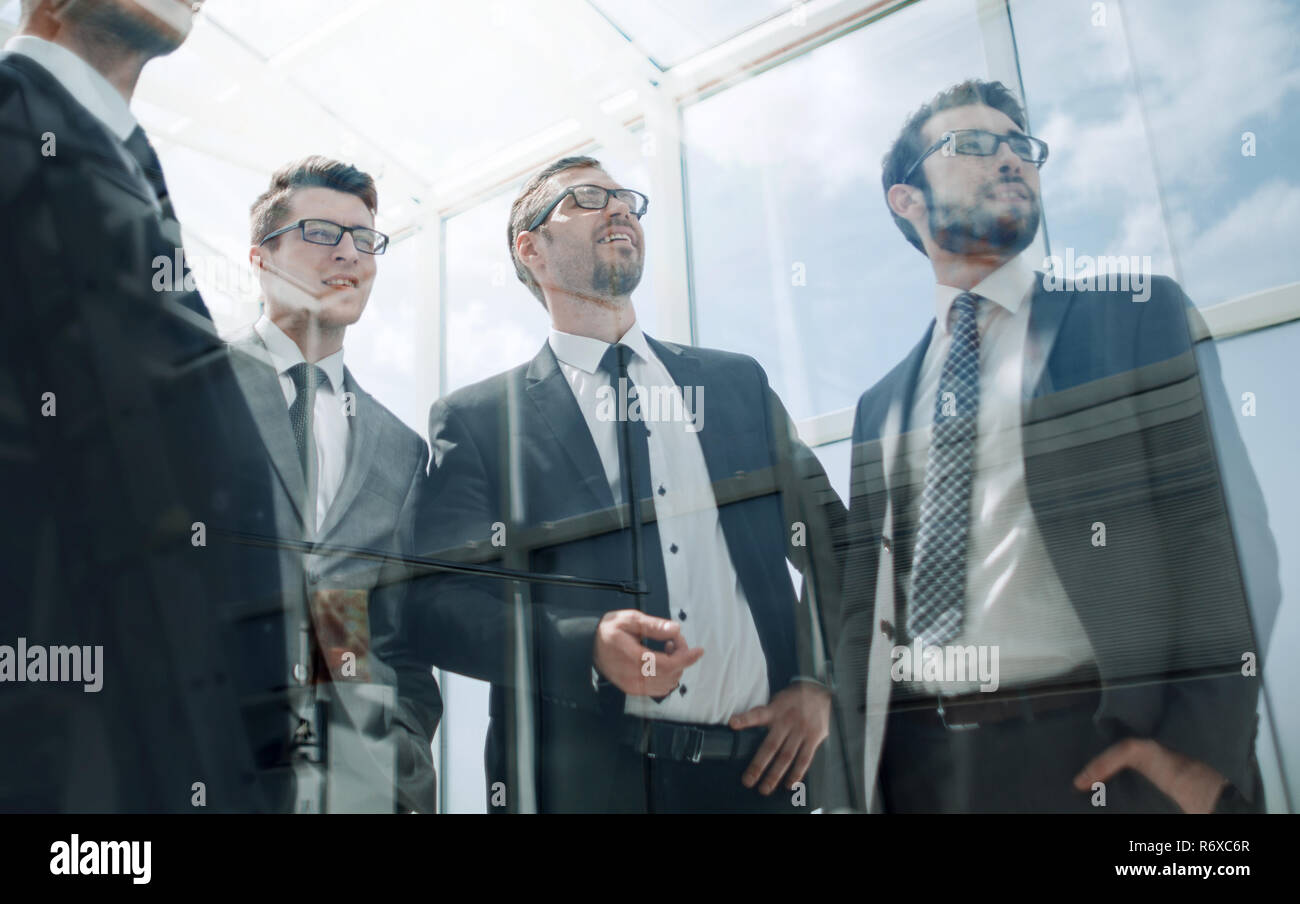 group of business people looking through the office window Stock Photo ...