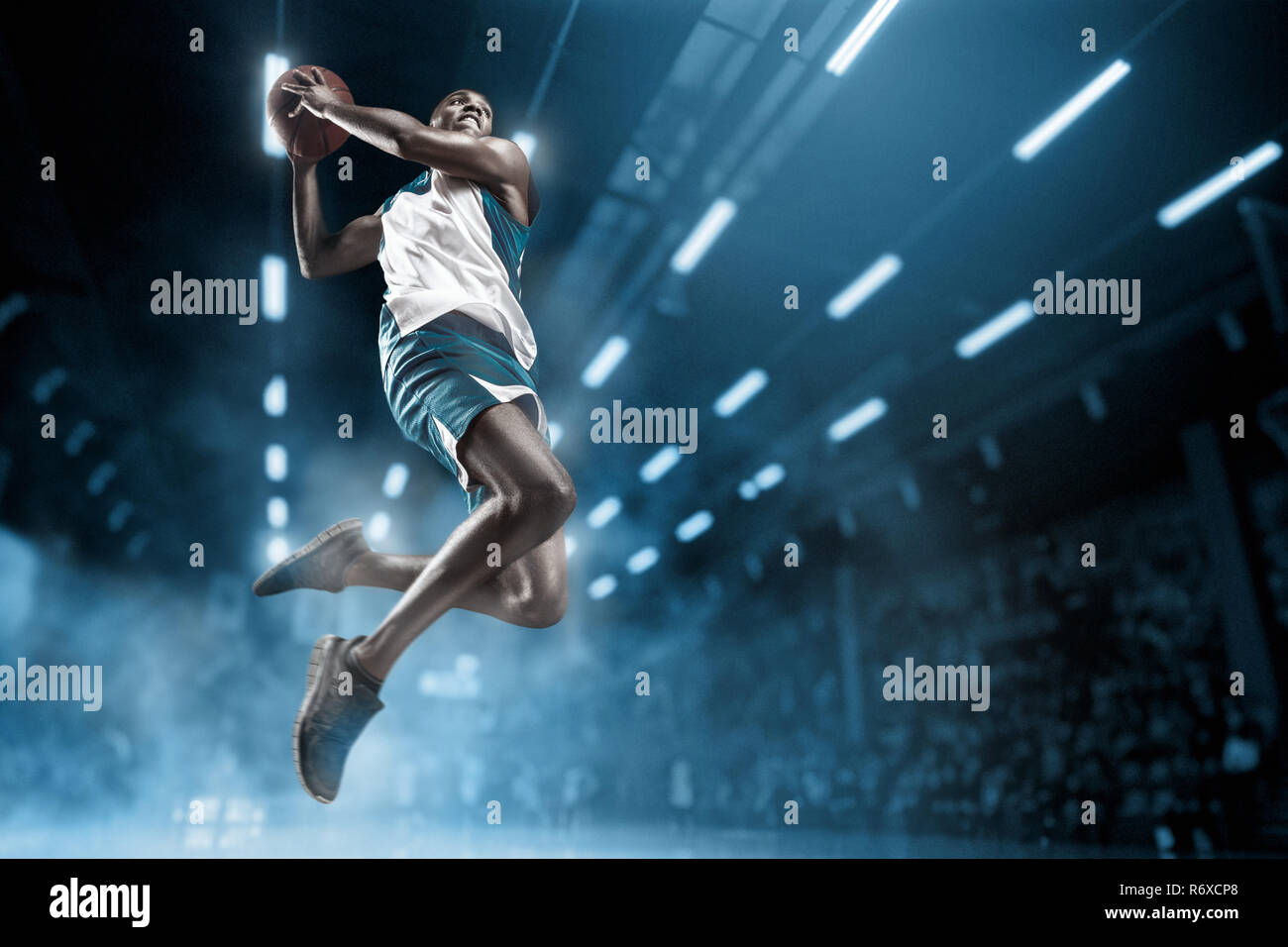 Basketball player on big professional arena during the game. Basketball ...