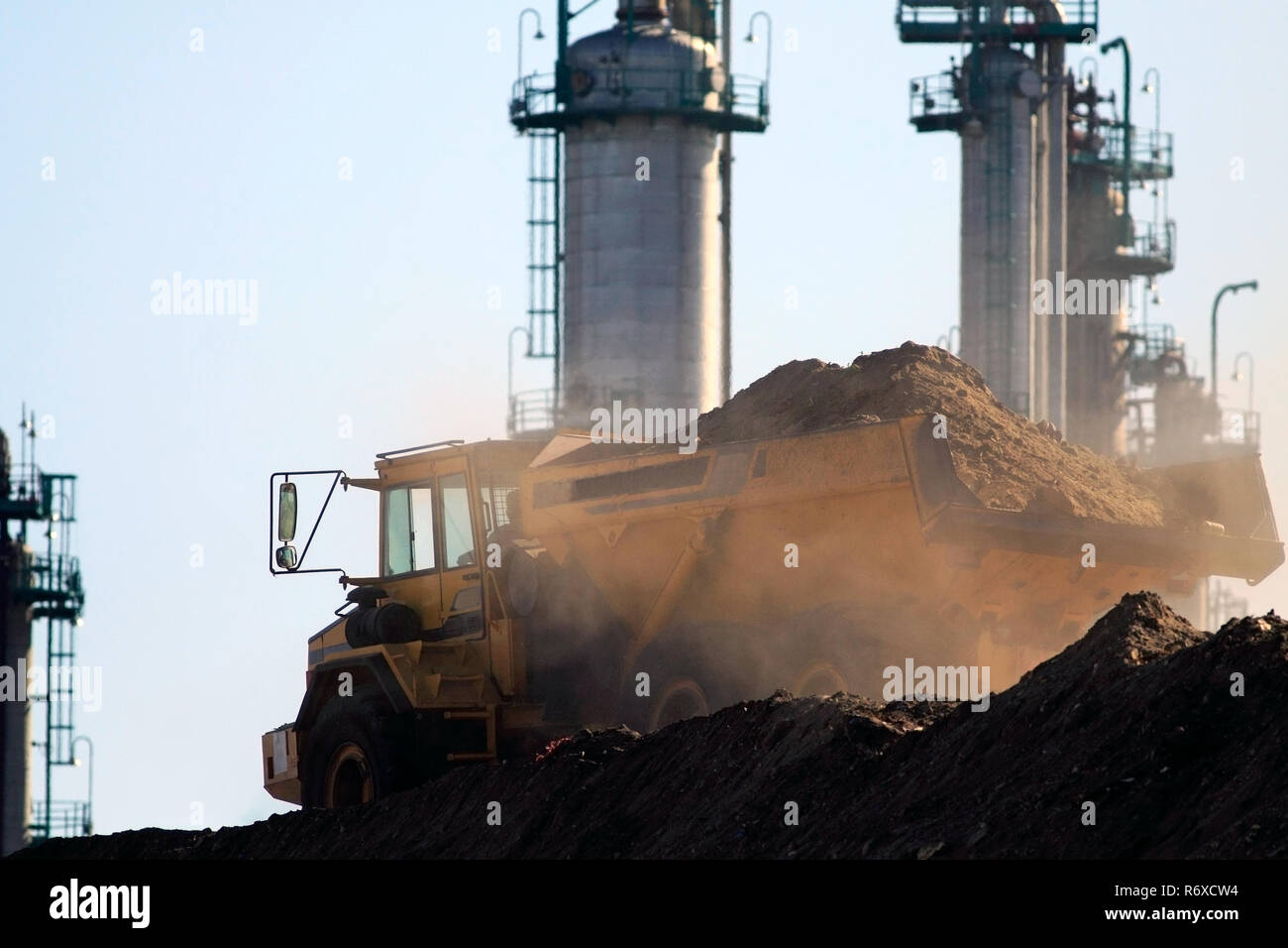 Heavy dump truck loaded with dirt working in the enlargement of a ...