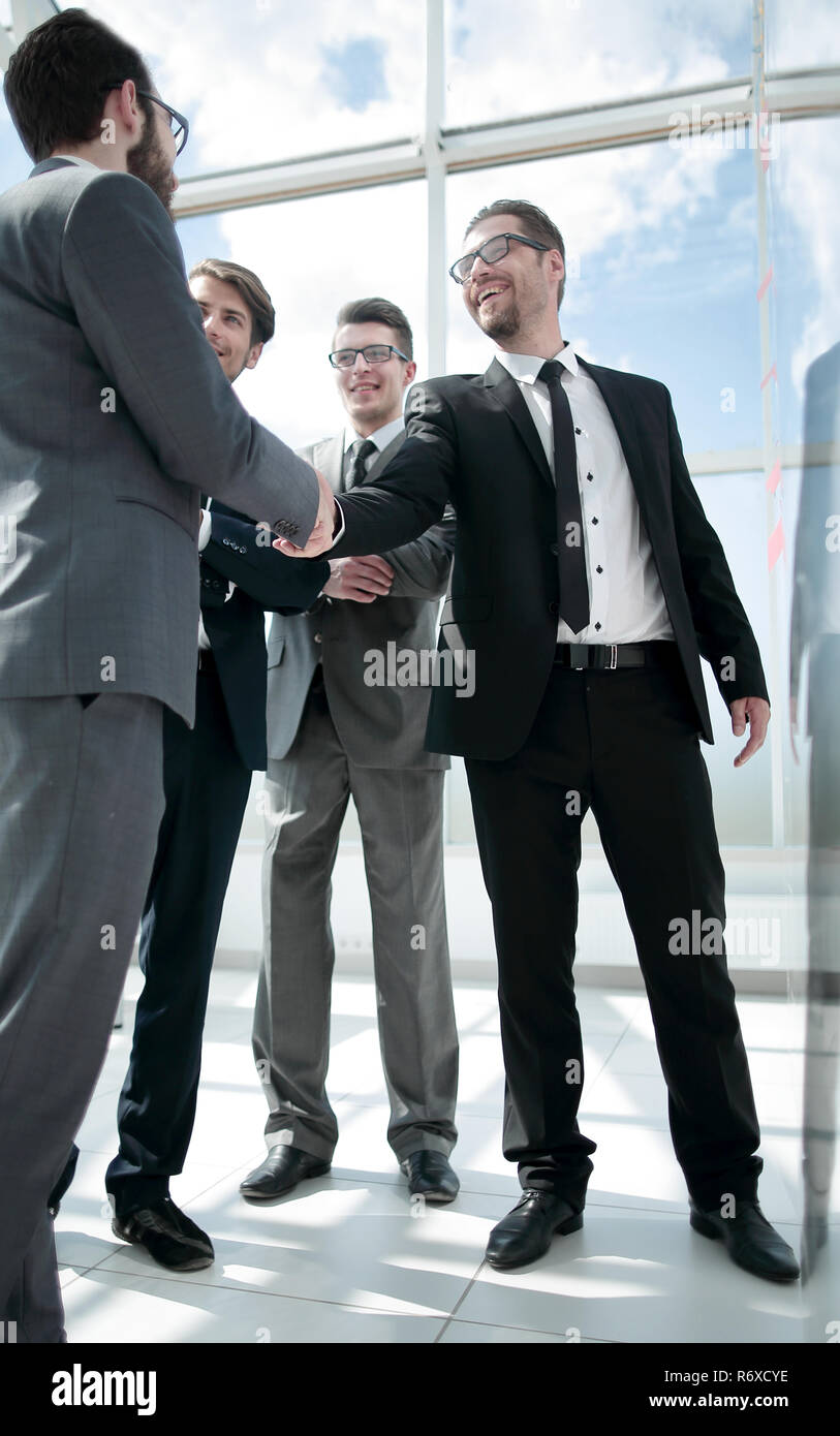 handshake of serious business partners standing in the office Stock Photo - Alamy