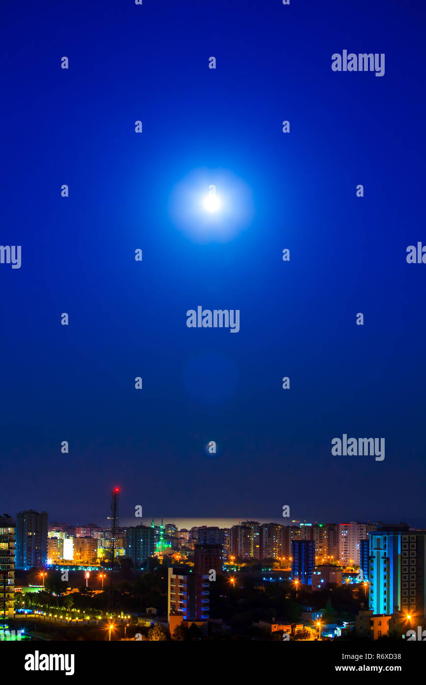 City Night View With Moon Stock Photo - Alamy
