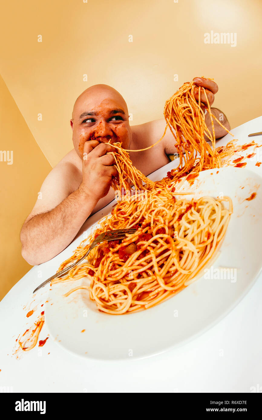 Crazy man eating plate of spaghetti Stock Photo - Alamy