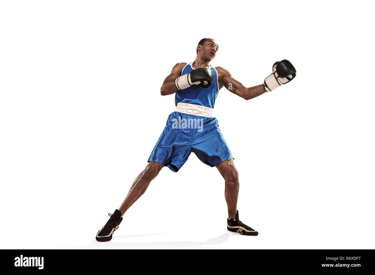 Sporty man during boxing exercise making hit. Photo of boxer on white ...