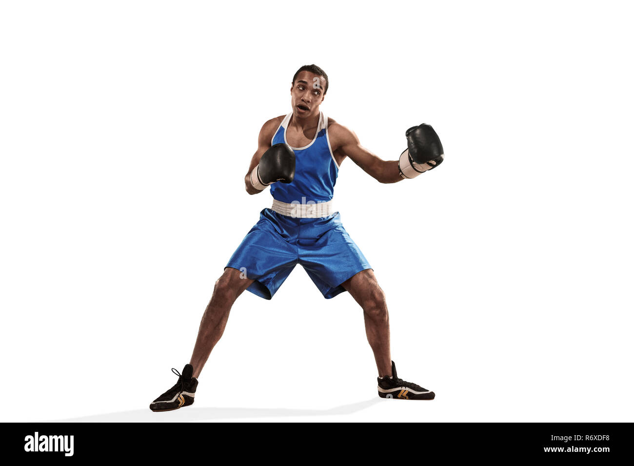 Sporty man during boxing exercise making hit. Photo of boxer on white ...