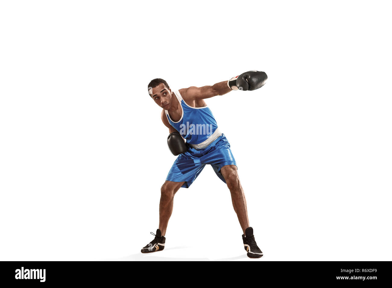 Sporty man during boxing exercise making hit. Photo of boxer on white ...