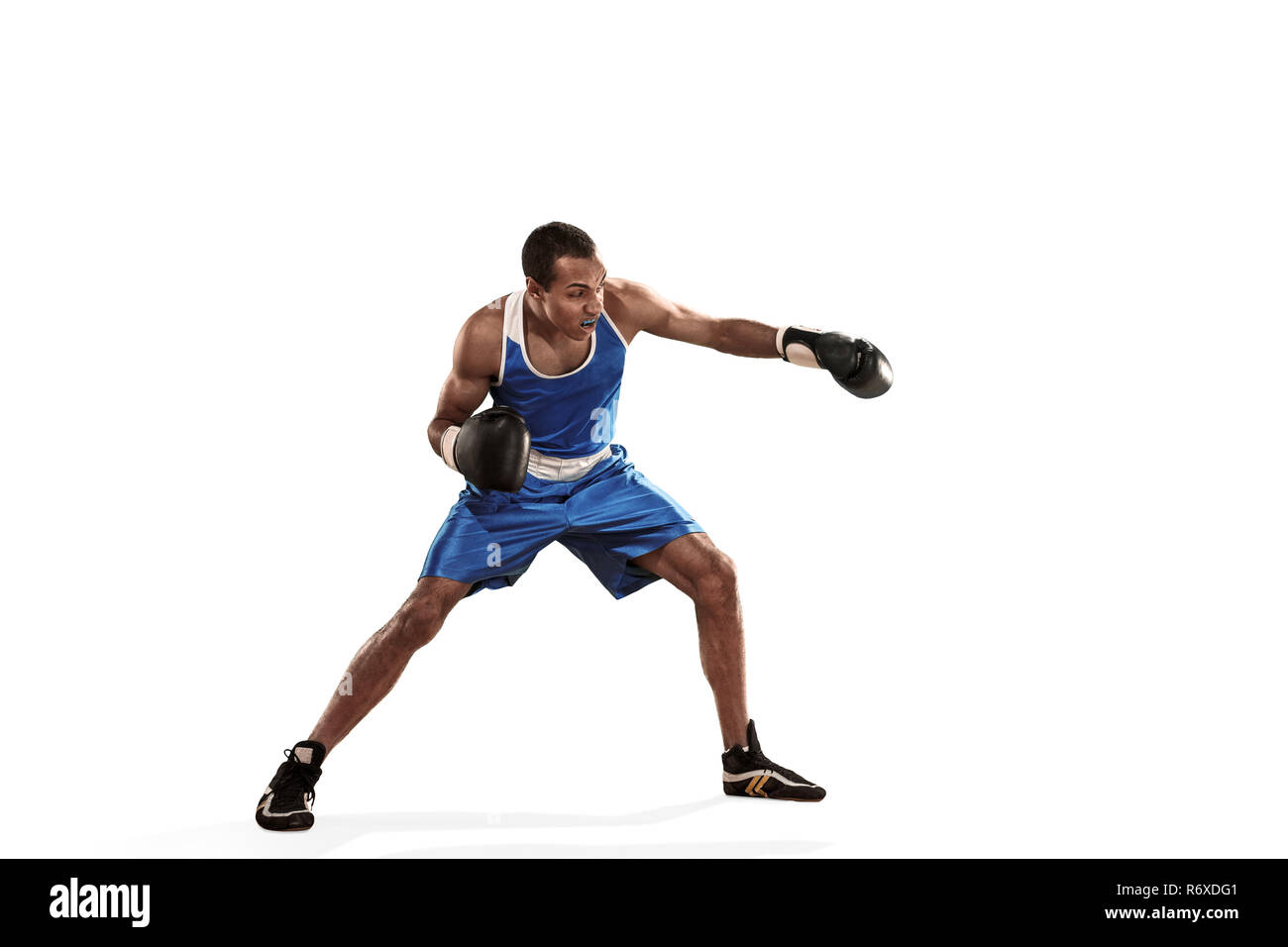 Sporty man during boxing exercise making hit. Photo of boxer on white ...