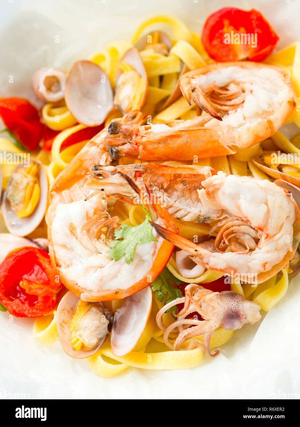 rustic seafood pasta papillote Stock Photo - Alamy