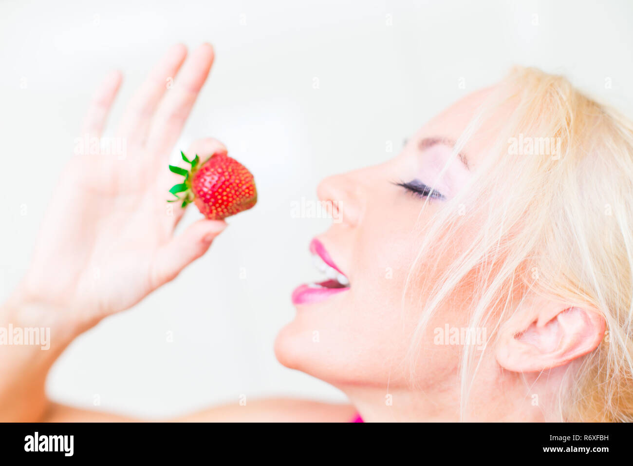 Happy woman cooks in the kitchen Stock Photo - Alamy