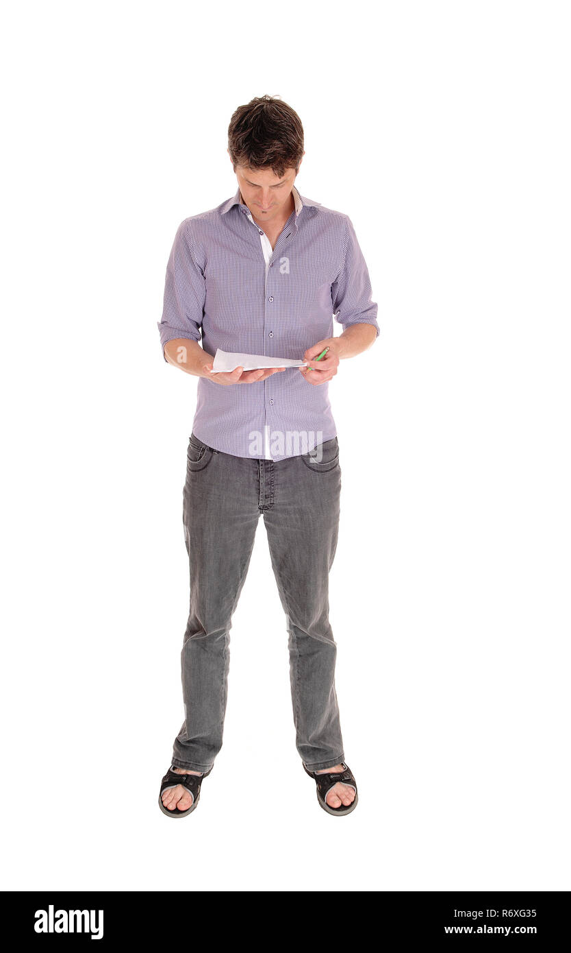 Young Caucasian man standing and reading Stock Photo - Alamy