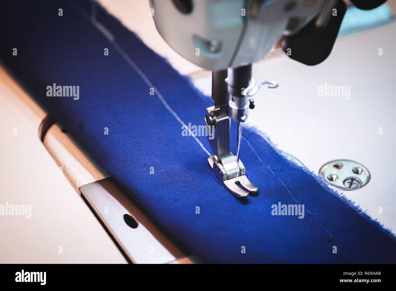 Sewing machine working part with blue cloth Stock Photo - Alamy