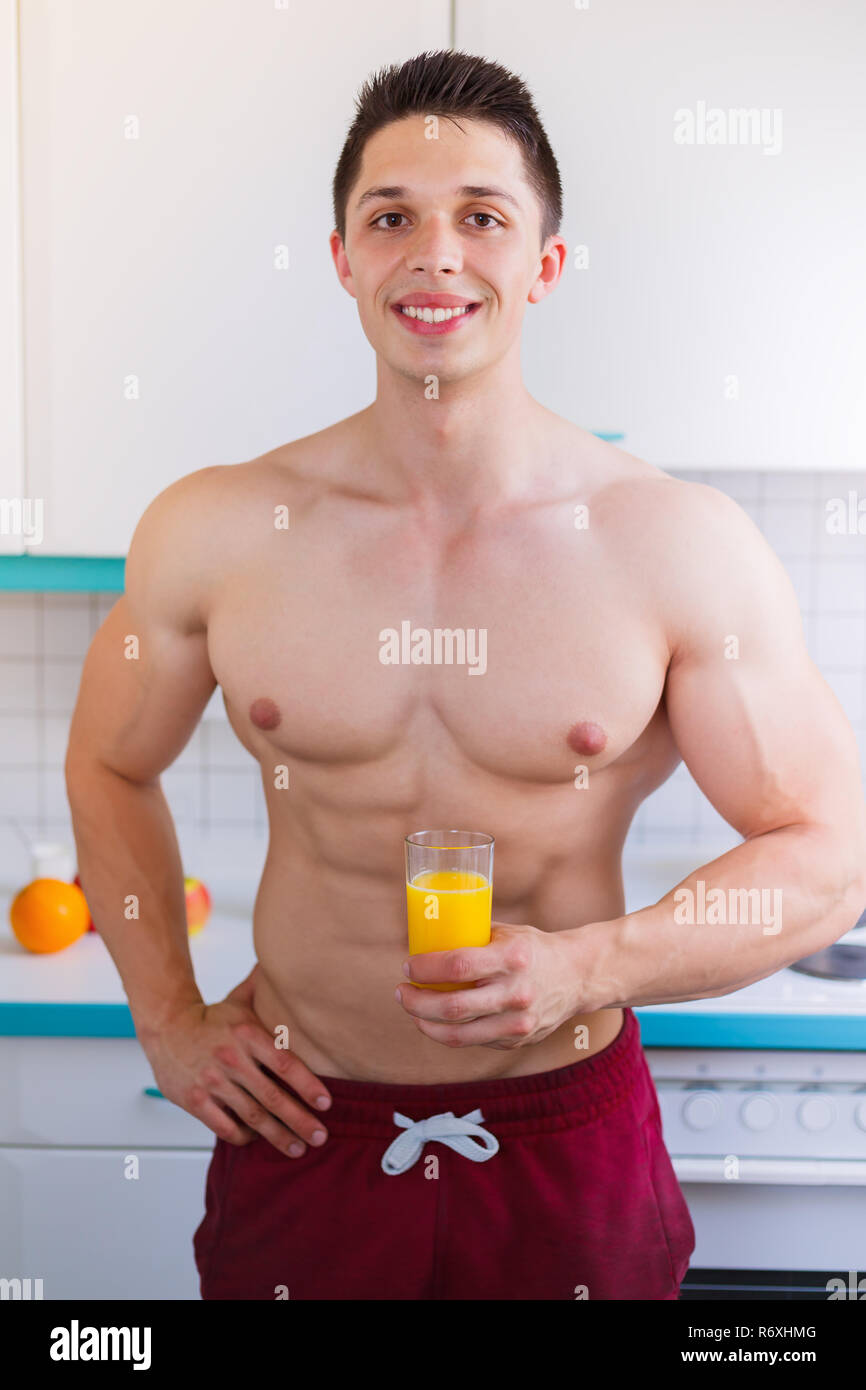 bodybuilder young man drinks drinking orange juice juice portrait ...
