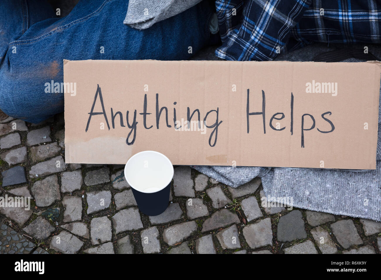 Elevated View Of Anything Helps Text On Cardboard Stock Photo - Alamy