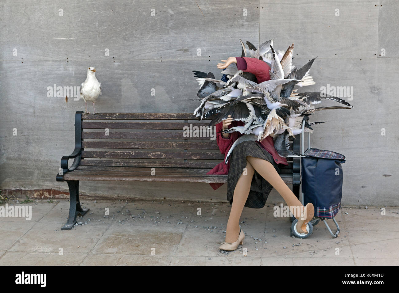 A sculpture of birds attacking a woman in a scene reminiscent of ...