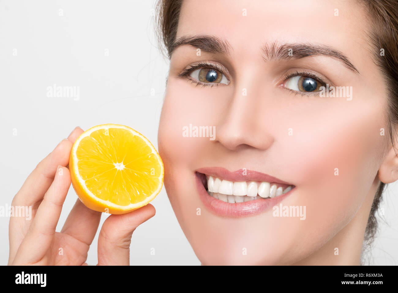 Beauty Female face with fresh lemon fruits Stock Photo - Alamy
