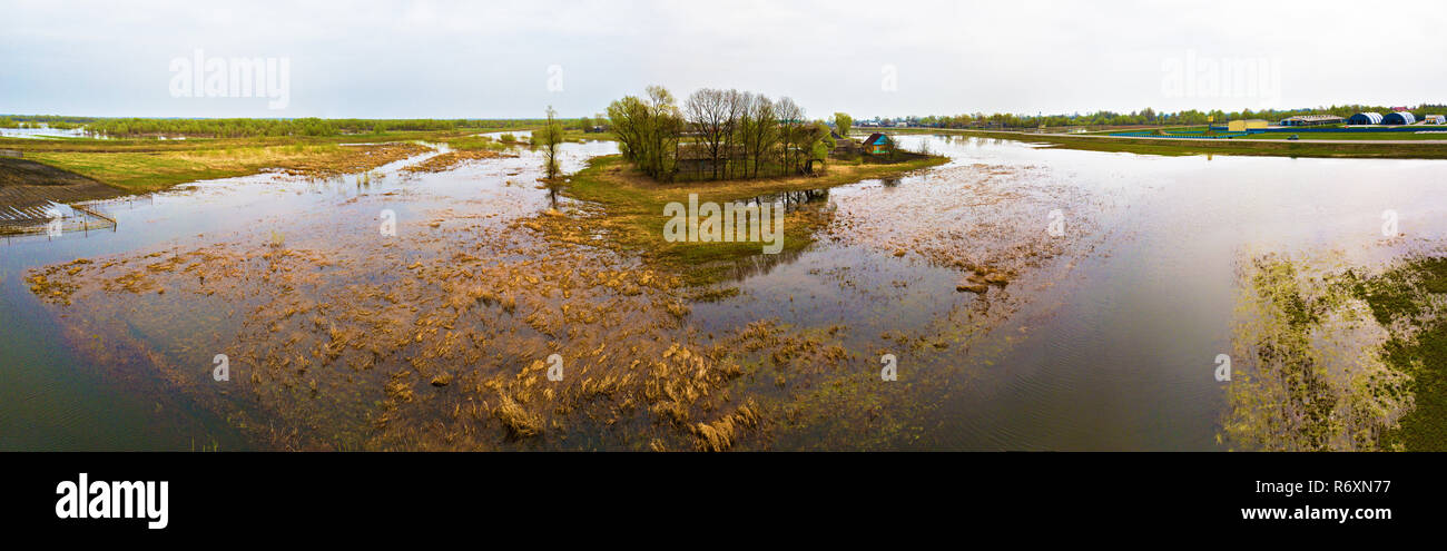 Spring melting river flood aerial panorama. Overflow water at ...