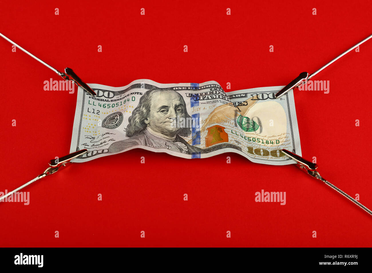 US dollar banknote stretched on red background Stock Photo - Alamy