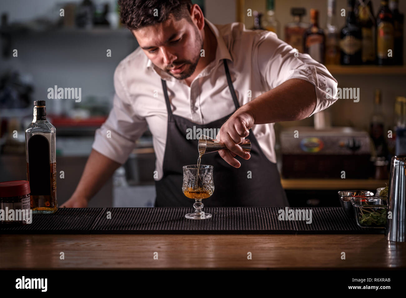 Bartender is pouring alcohol Stock Photo - Alamy