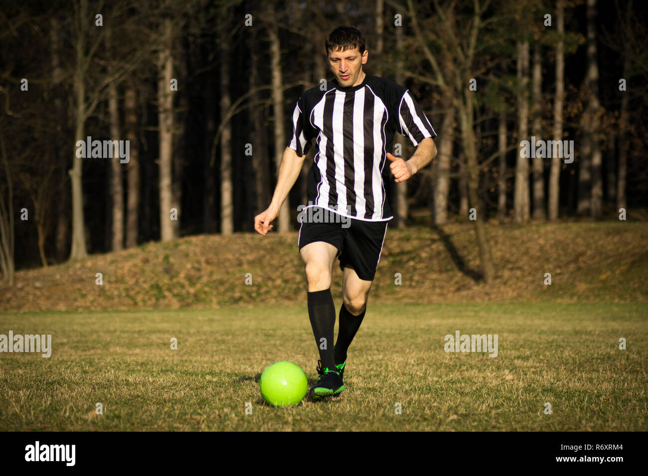 playing soccer player Stock Photo - Alamy