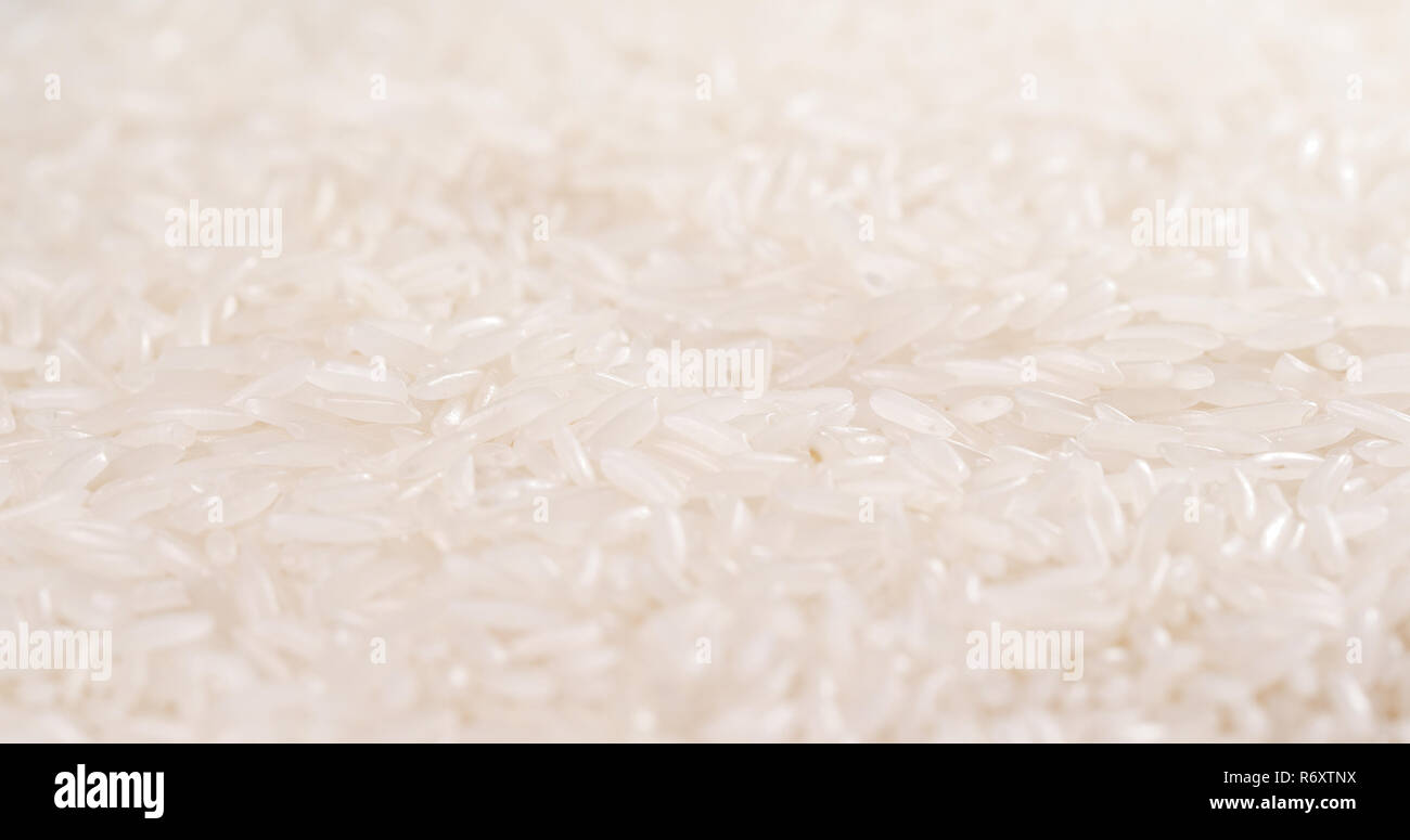 Pile of raw rice Stock Photo - Alamy