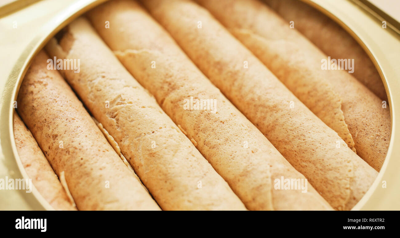 Egg roll inside metal tin can Stock Photo - Alamy