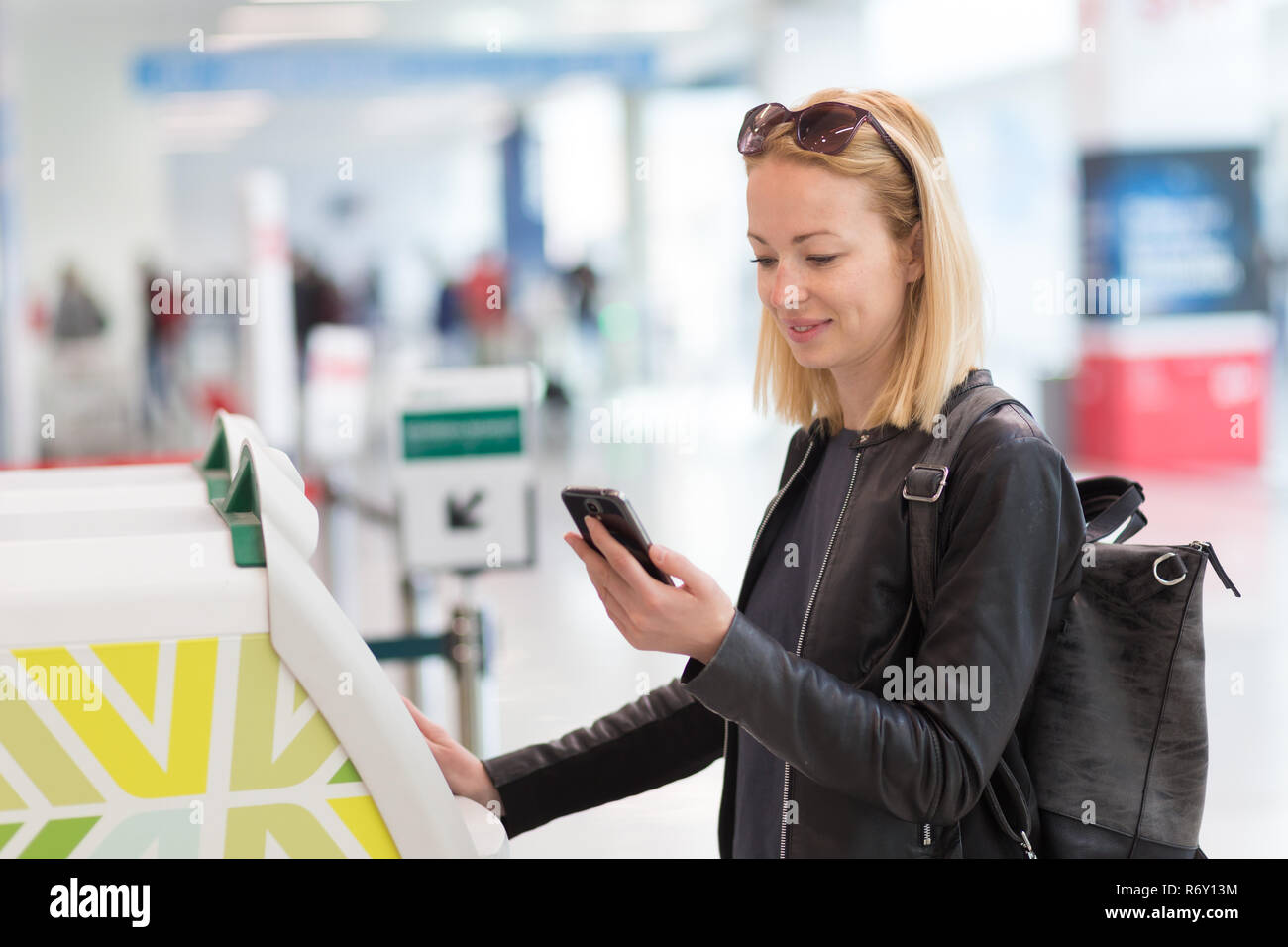 Casual caucasian woman using smart phone application and check-in ...