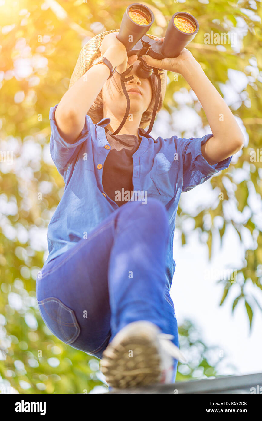 Close up Woman wear hat and hold binocular in grass field Stock Photo ...