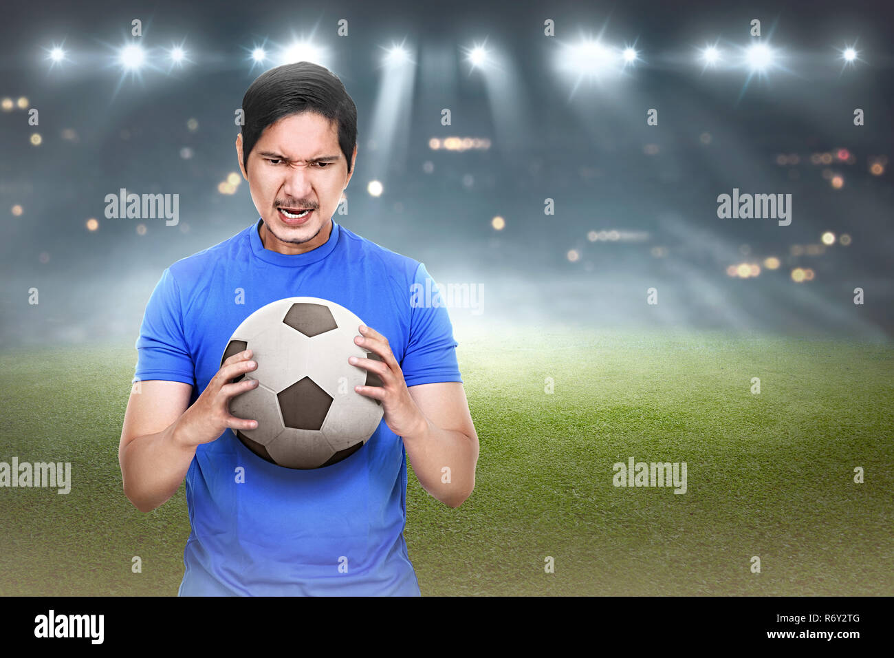 Attractive asian soocer player with ball on his hand Stock Photo - Alamy