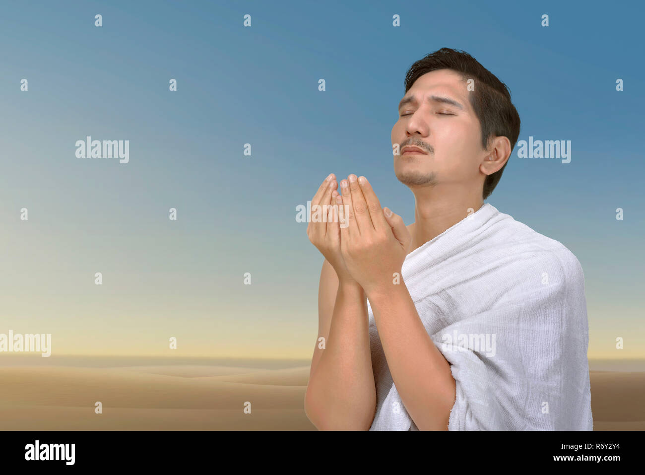 Young asian muslim man praying to god Stock Photo - Alamy