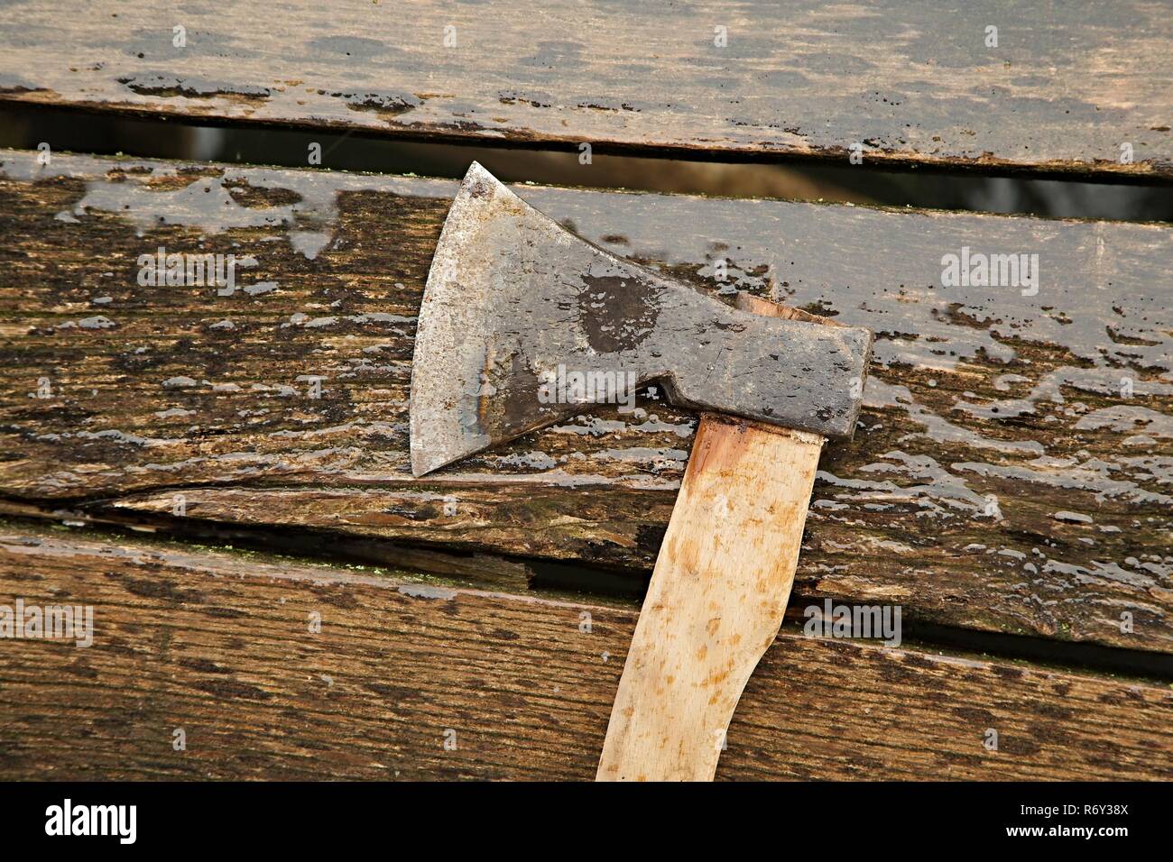 Axe on wet planks Stock Photo - Alamy