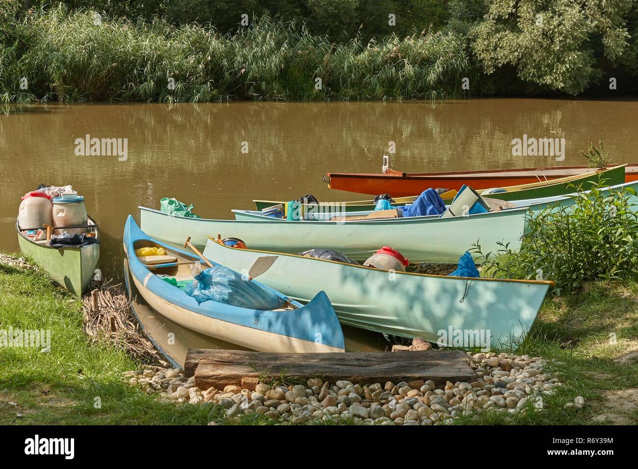 Canoes on the Riverside Stock Photo - Alamy