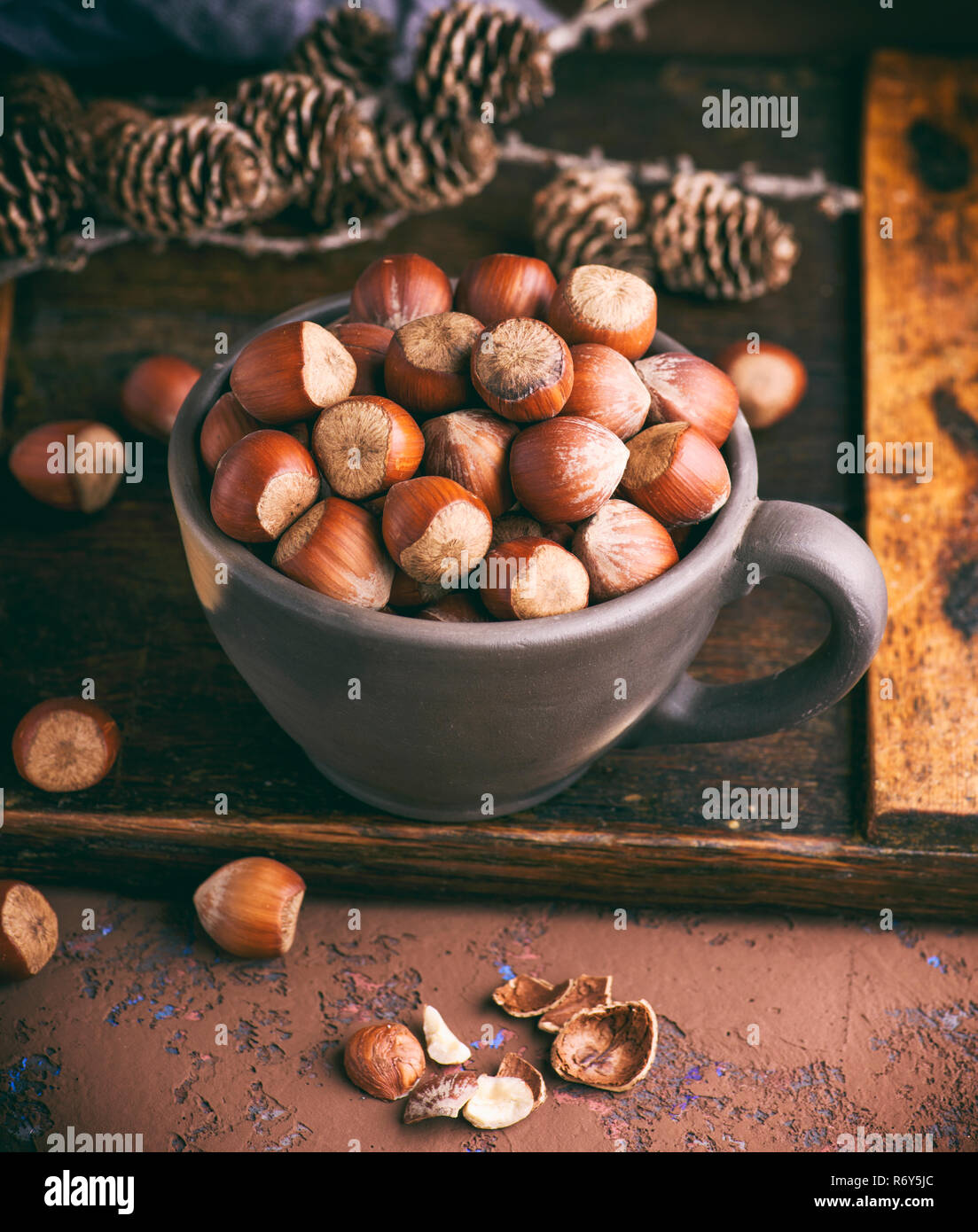 hazelnut in a shell in a brown clay cup Stock Photo - Alamy