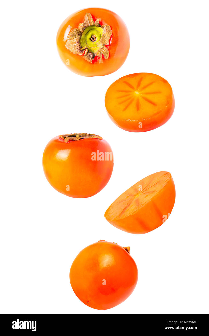 falling sweet perssimon fruits isolated on white Stock Photo - Alamy
