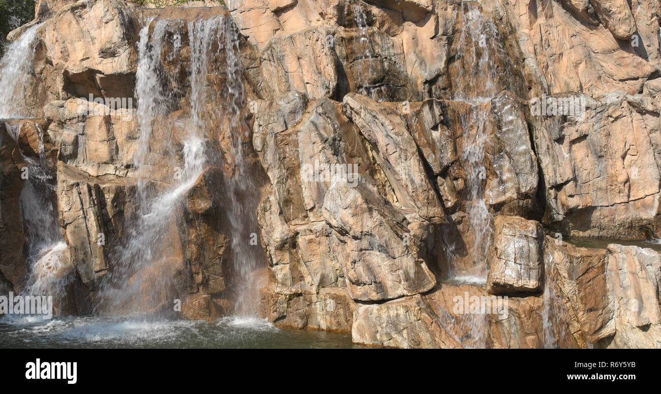 Waterfall over the rock wall Stock Photo - Alamy