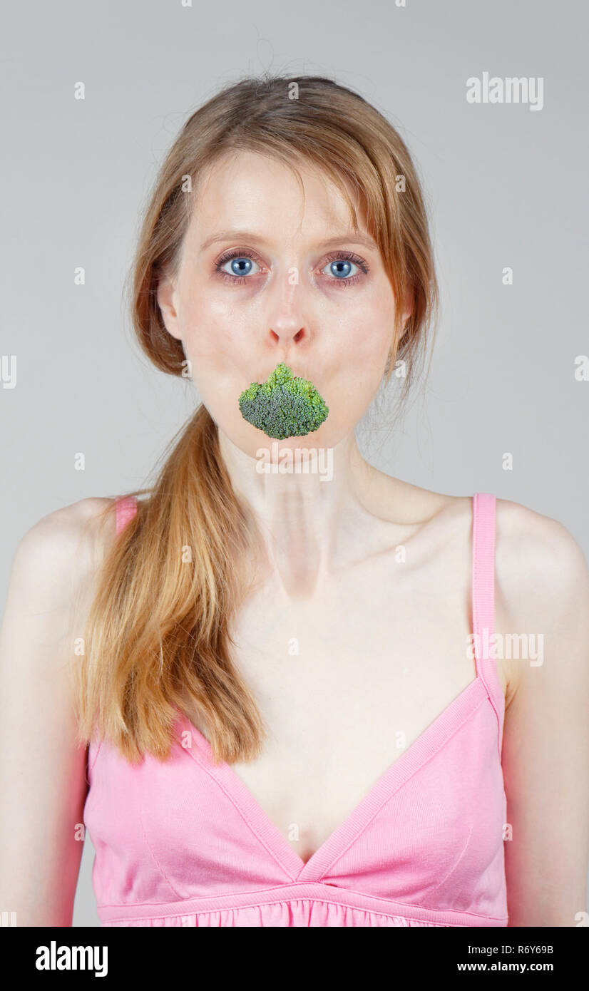 Broccoli inside mouth Stock Photo - Alamy