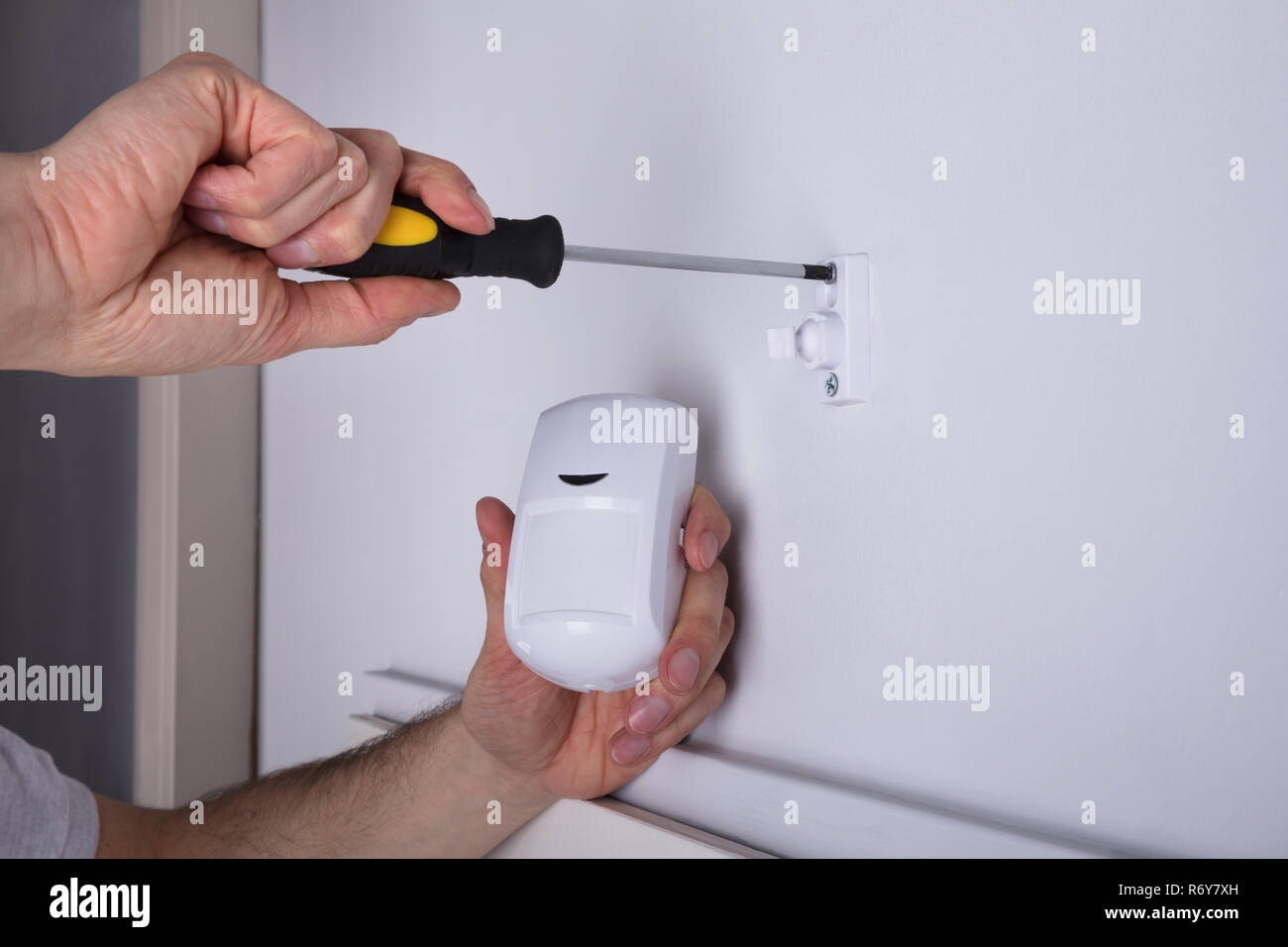 Electrician Installing Security System Door Sensor On Wall Stock Photo ...