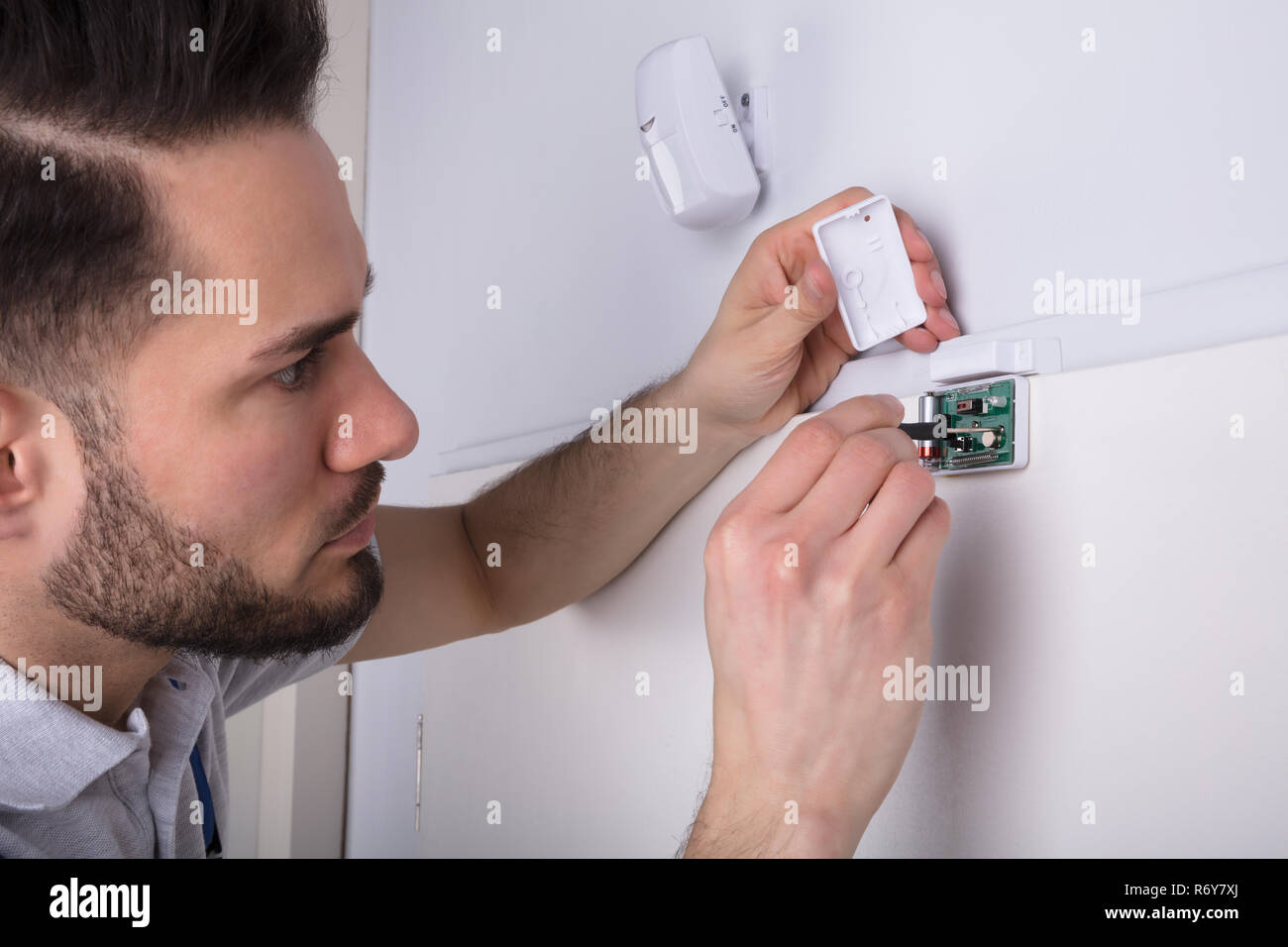 Technician Installing Security System Door Sensor Stock Photo - Alamy