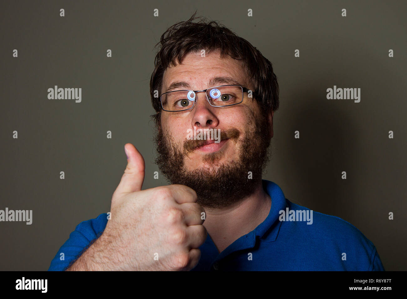 lazy man giving a thumbs up Stock Photo - Alamy