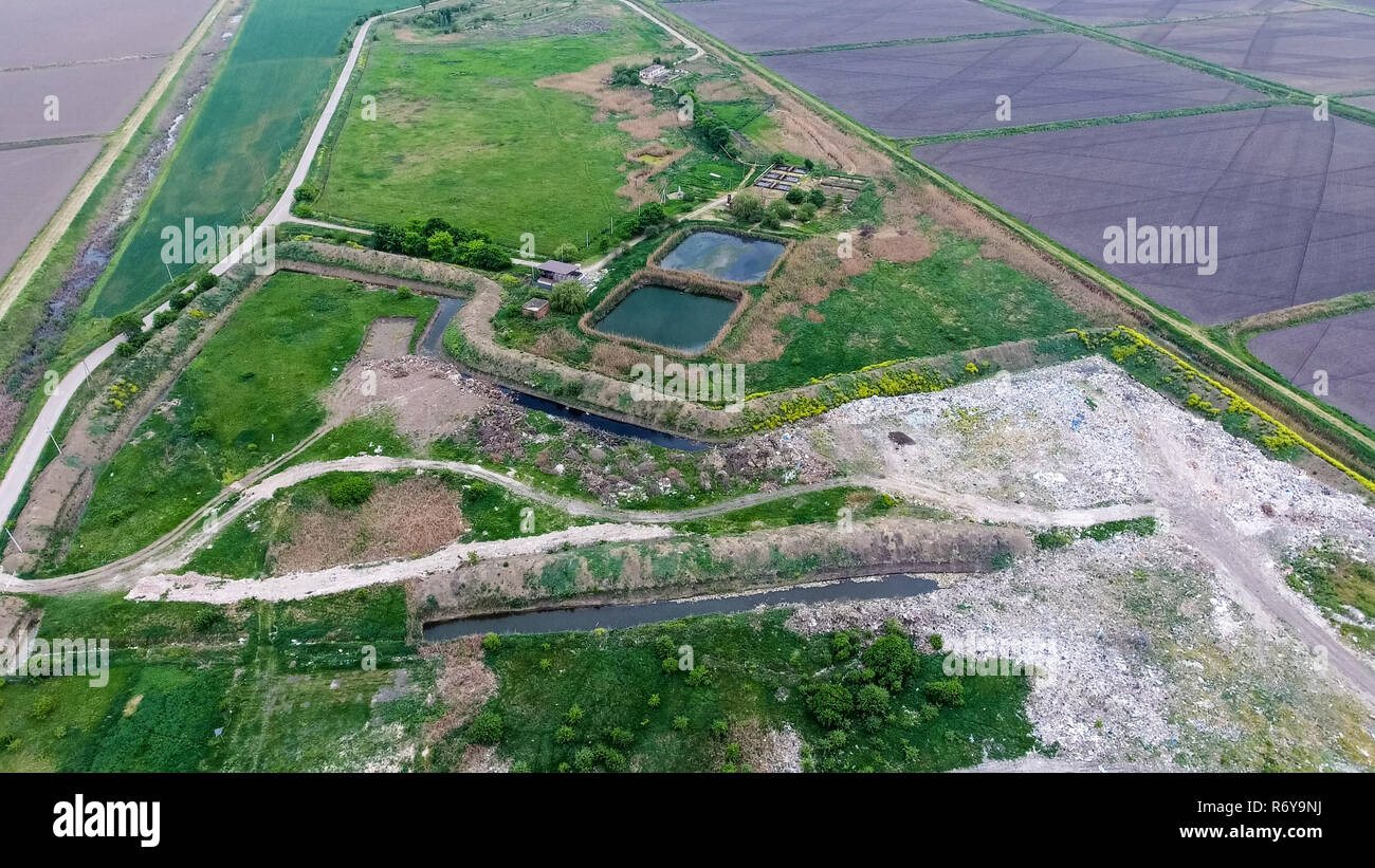 Purification facilities, sewage treatment pools. Landfill of garbage ...