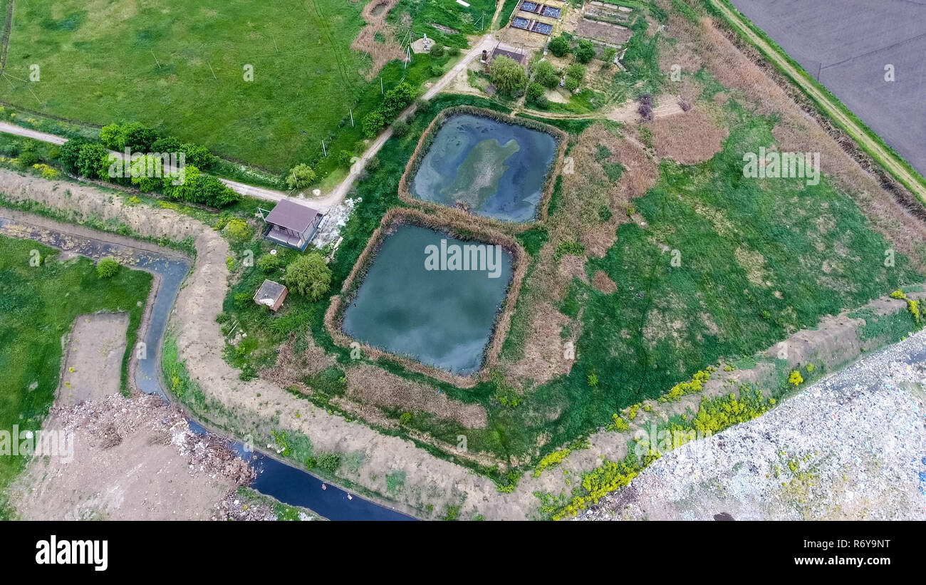 Purification facilities, sewage treatment pools. Landfill of garbage ...
